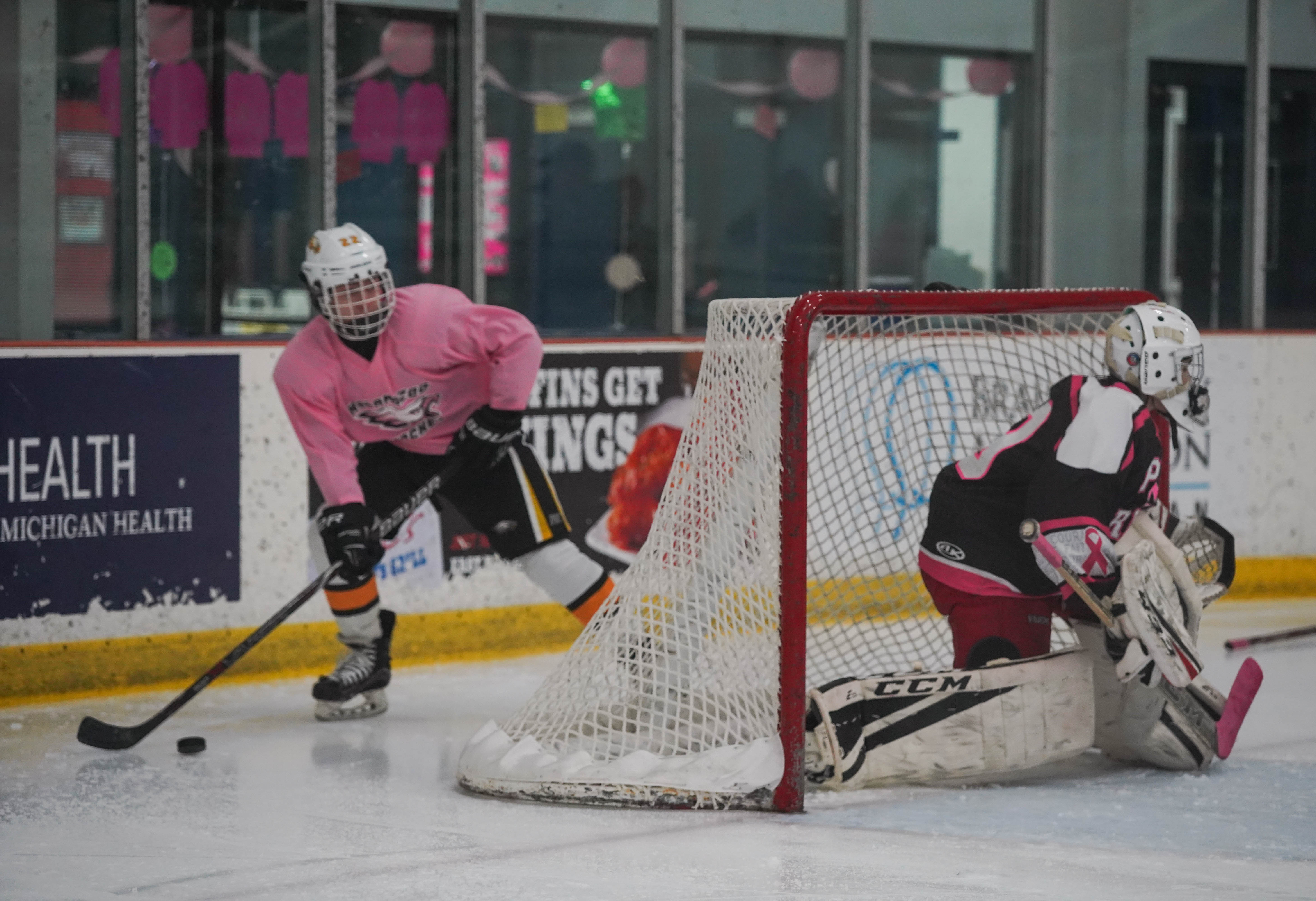 Hockey players honor cancer victims with special pink jerseys - mlive.com