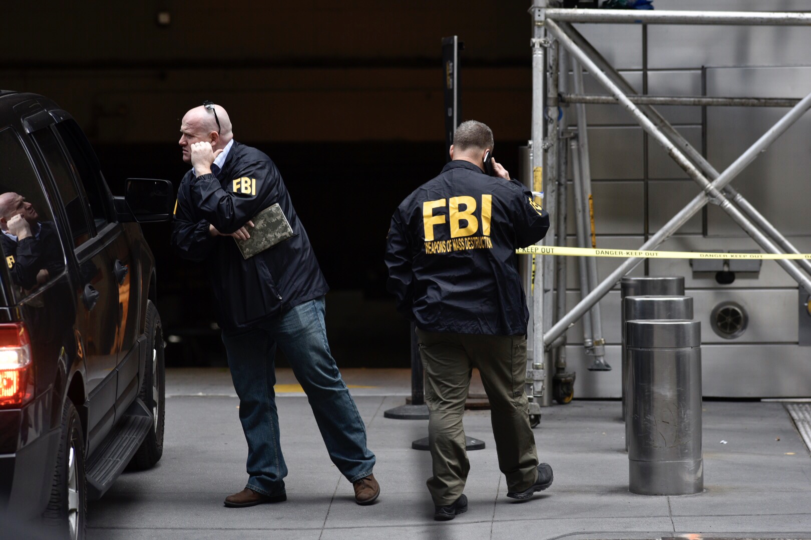 Law Enforcement officials respond to the scene of a suspicious package ...