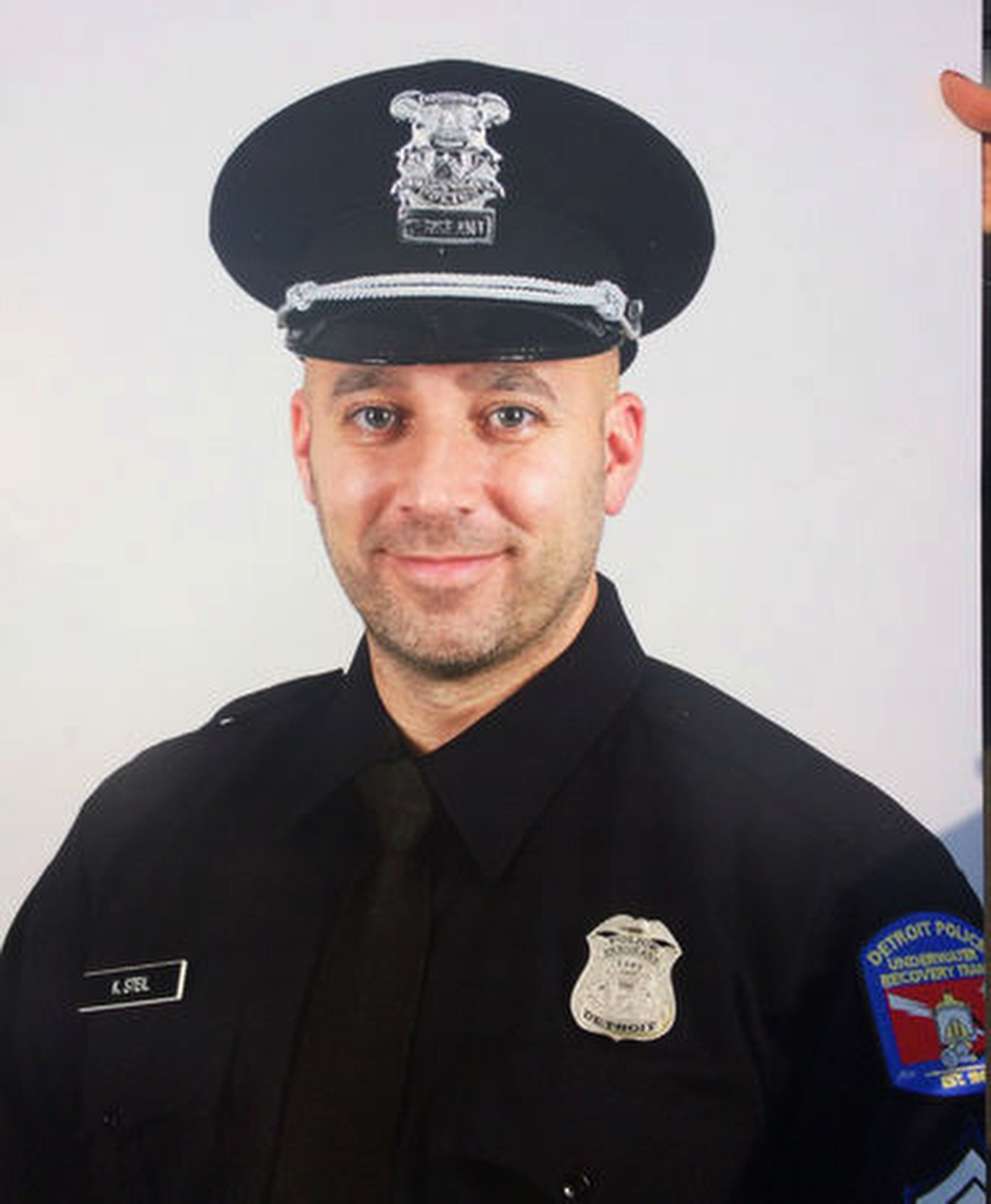 Detroit police Sgt. Kenneth Steil and Marquise Cromer - mlive.com