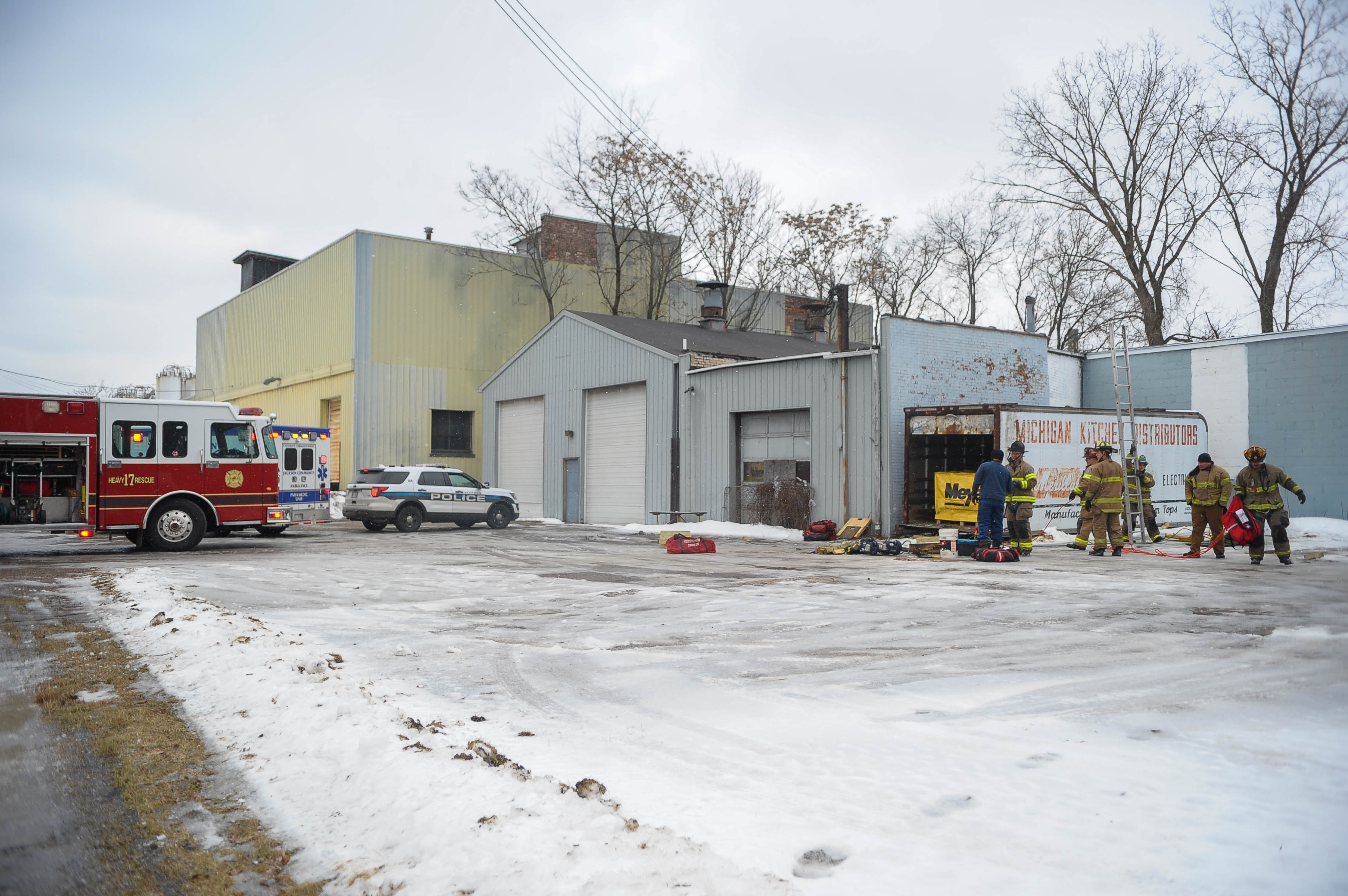 Man stuck between trailer and building - mlive.com